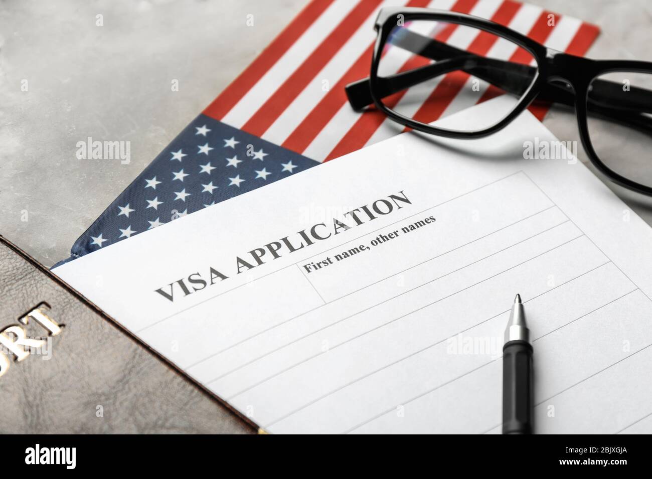 Passport, American flag and visa application form on table. Immigration ...