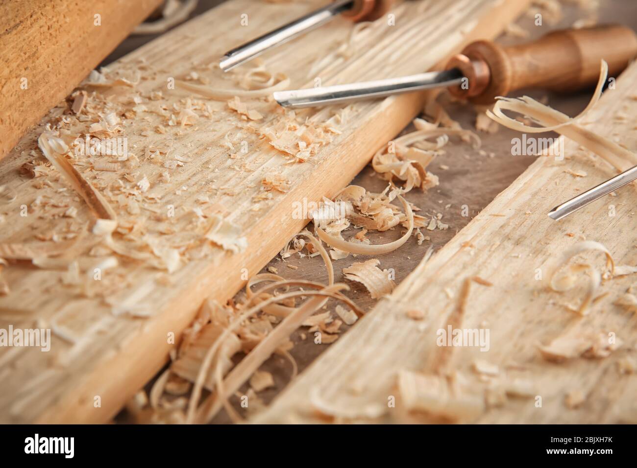 Chisels, wooden boards and sawdust in carpenter's workshop Stock Photo ...