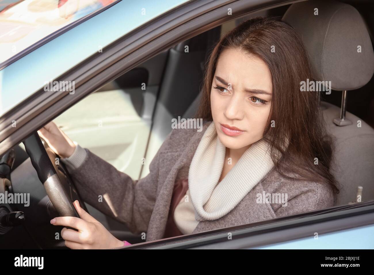 Young woman in car during traffic jam Stock Photo - Alamy