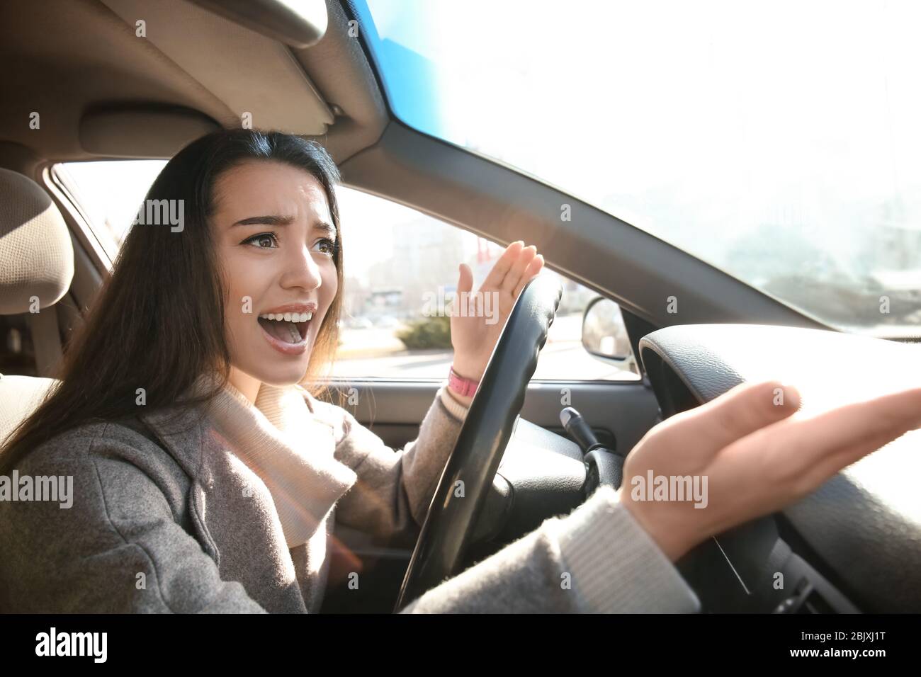 Young woman in car during traffic jam Stock Photo - Alamy