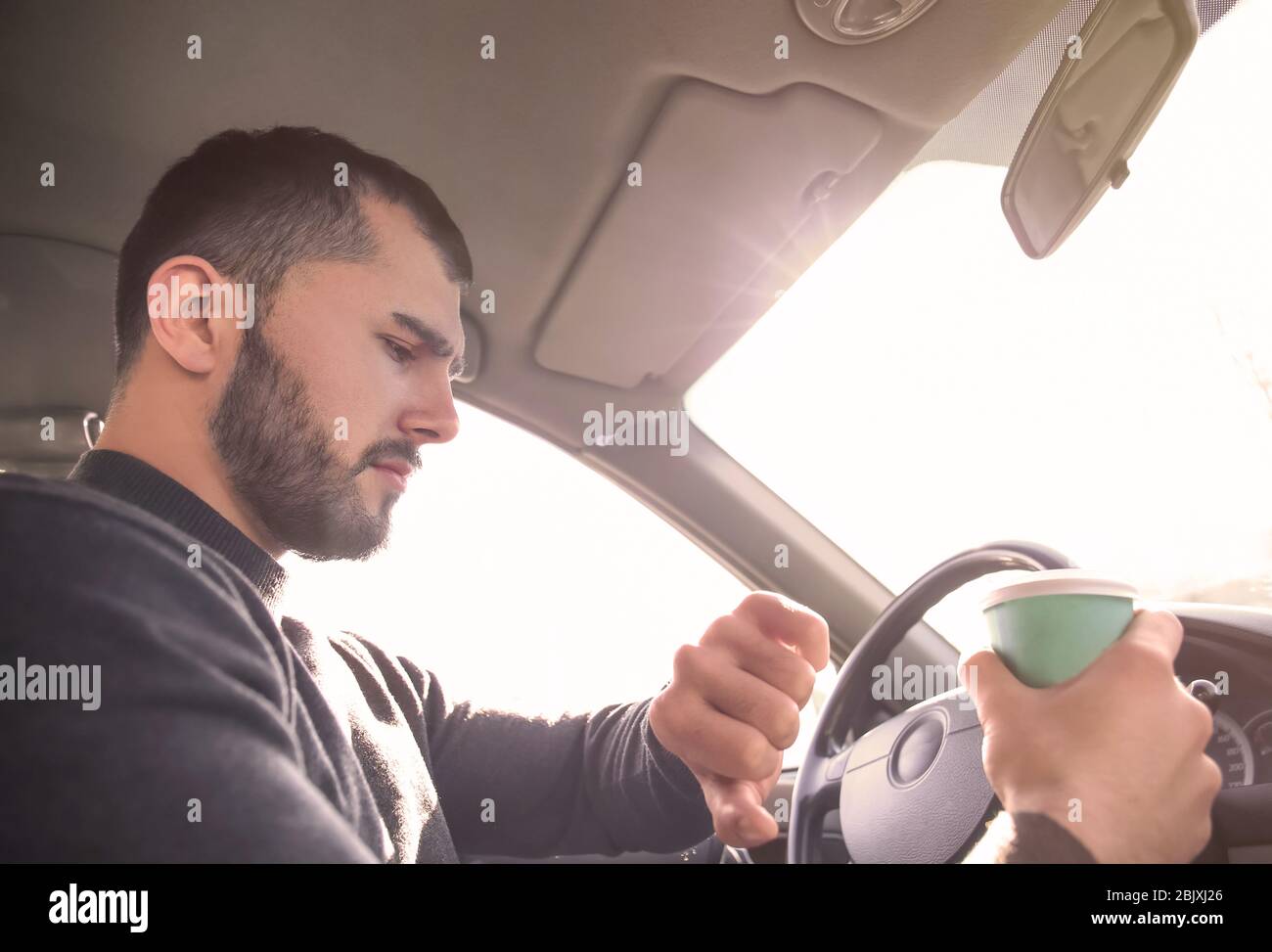 Young man in car during traffic jam Stock Photo - Alamy