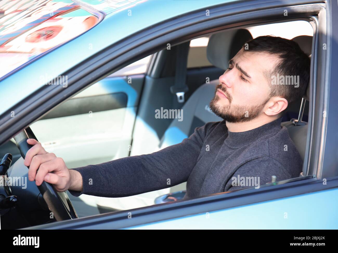 Young man in car during traffic jam Stock Photo - Alamy