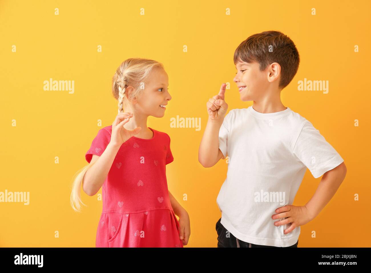 Little deaf mute children using sign language on color background Stock ...