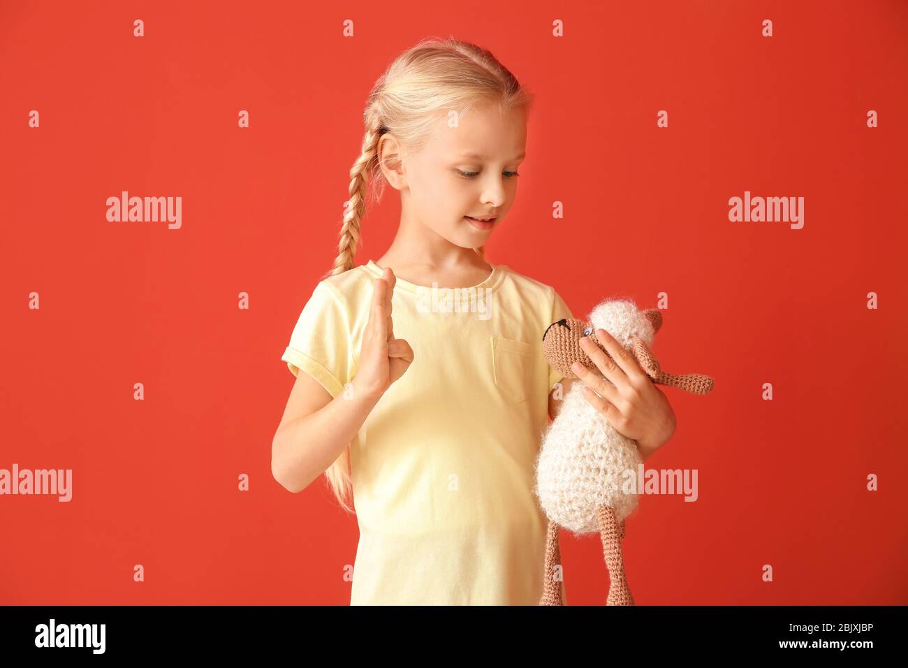 Little deaf mute girl using sign language on color background Stock ...