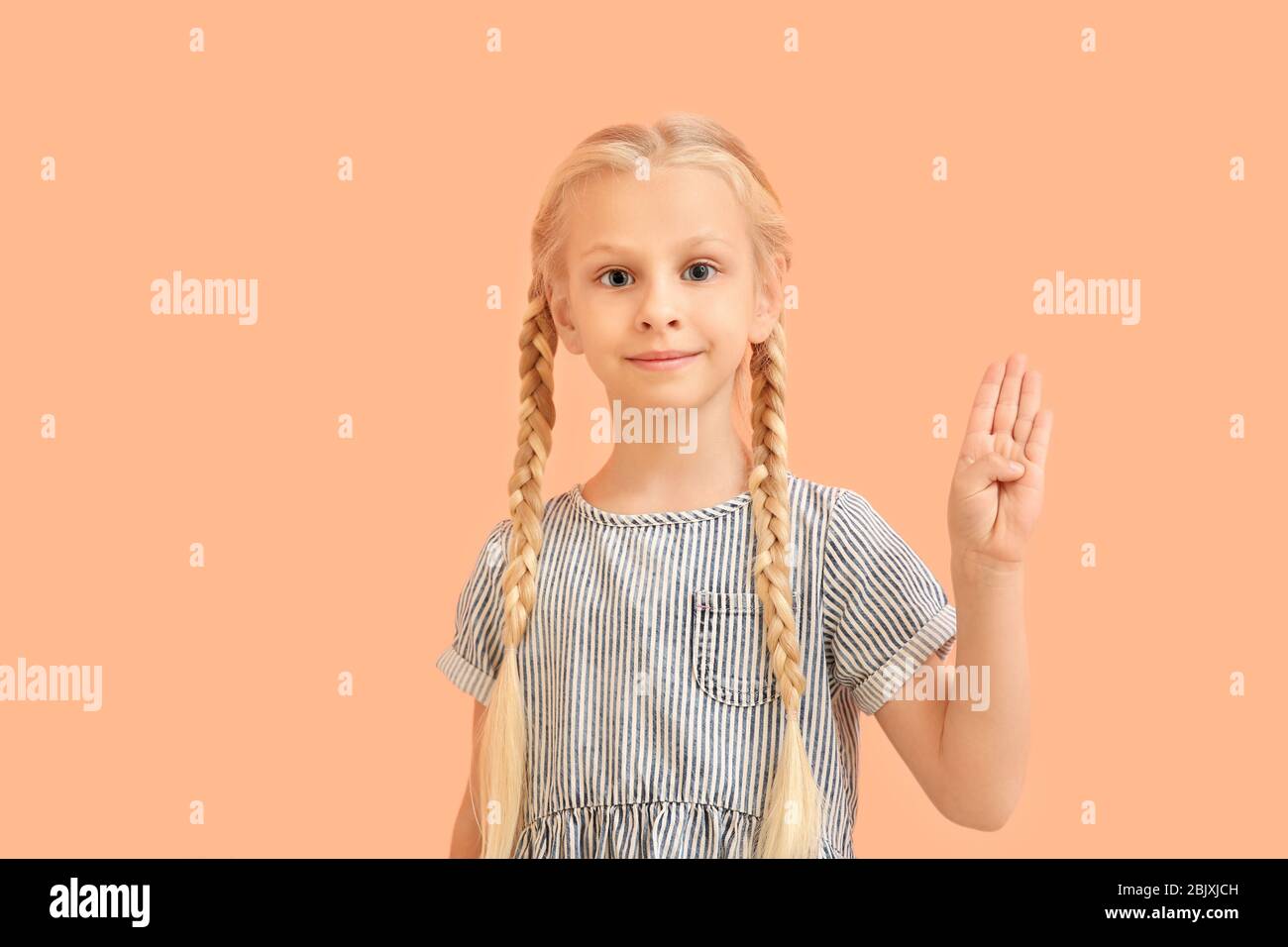 Little deaf mute girl using sign language on color background Stock ...