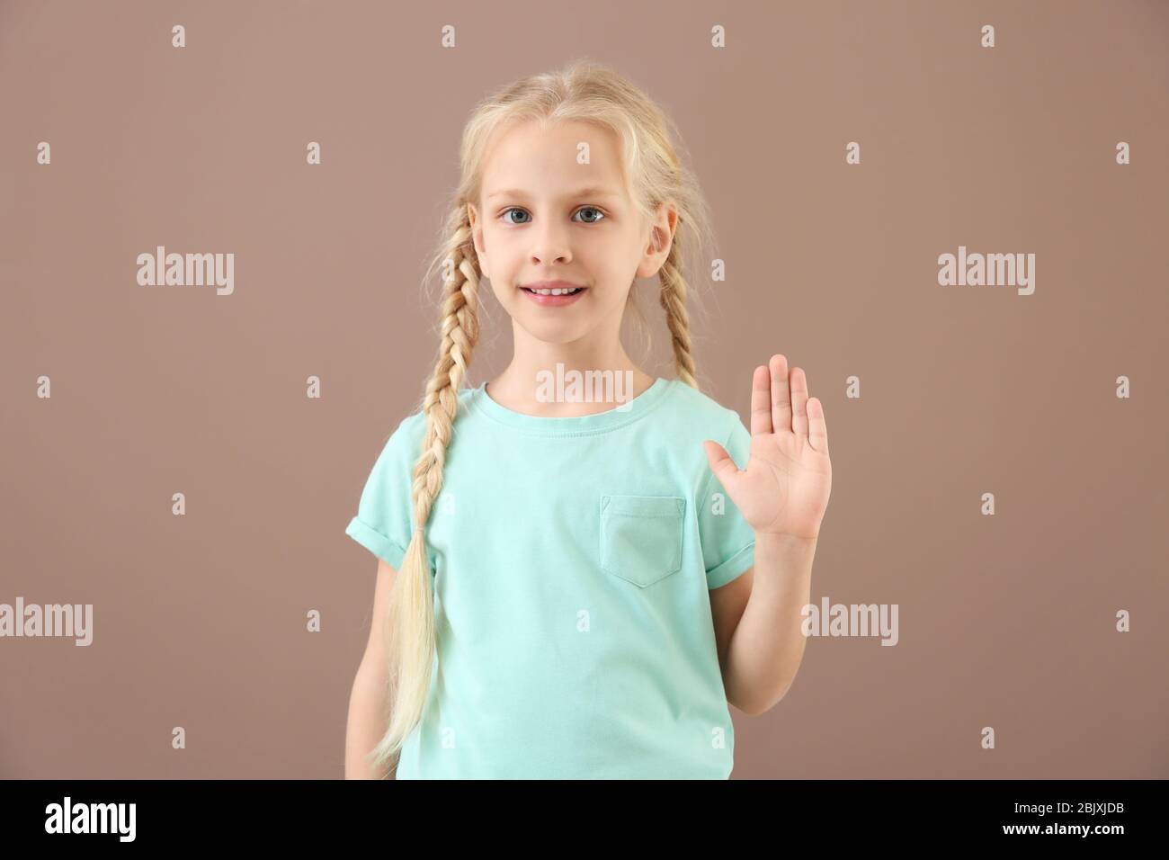 Little deaf mute girl using sign language on color background Stock ...