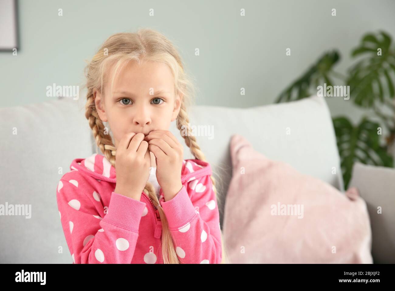 Little deaf mute girl using sign language at home Stock Photo - Alamy