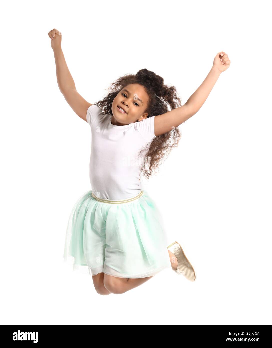 Jumping African-American girl on white background Stock Photo - Alamy