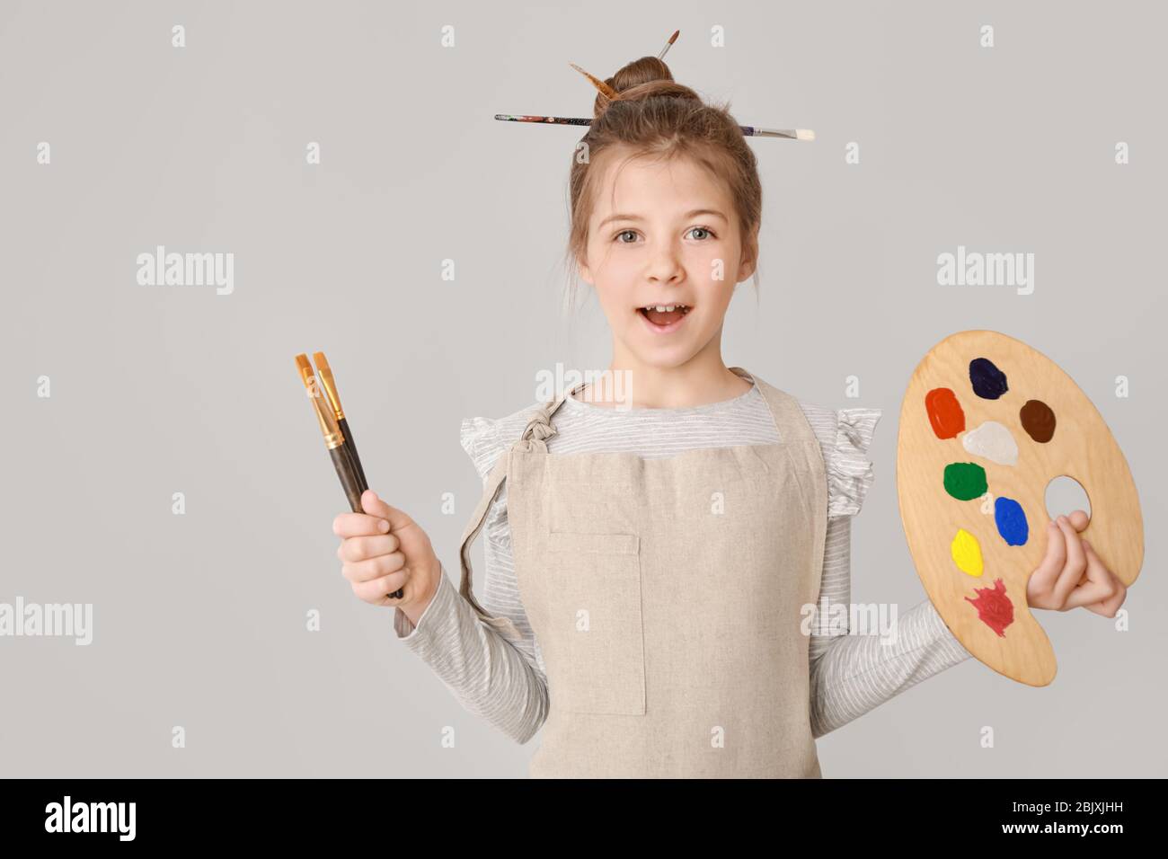 Cute little artist on light background Stock Photo - Alamy