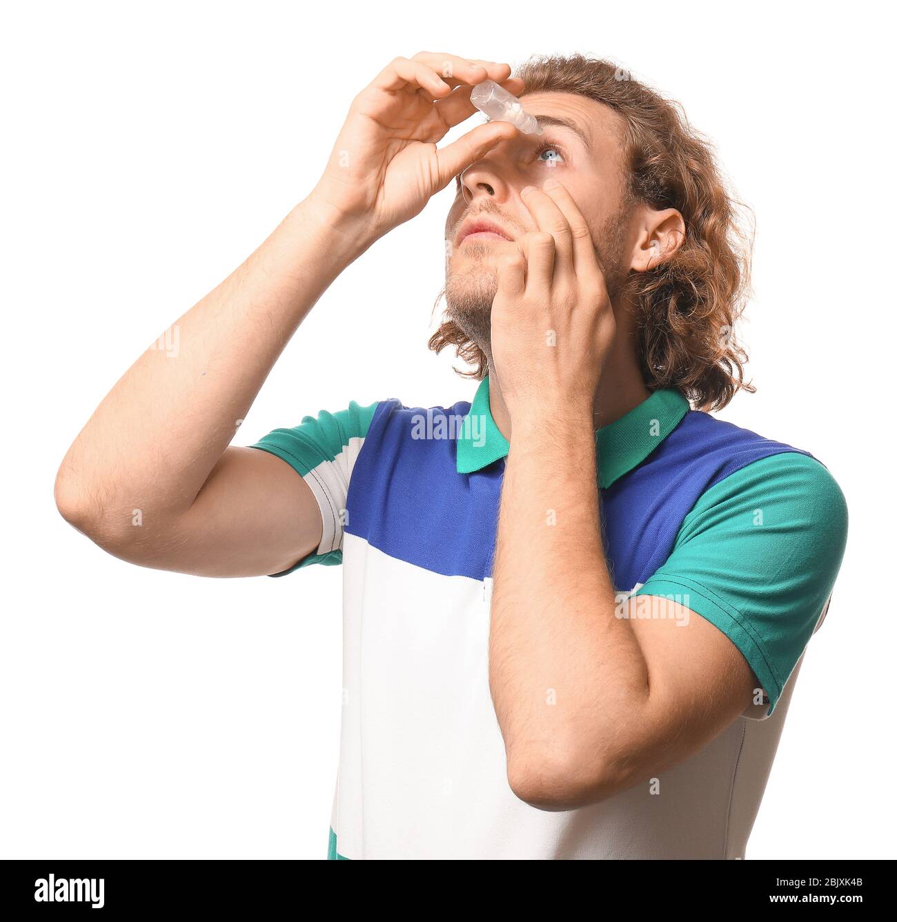 Young man with eye drops on white background Stock Photo - Alamy