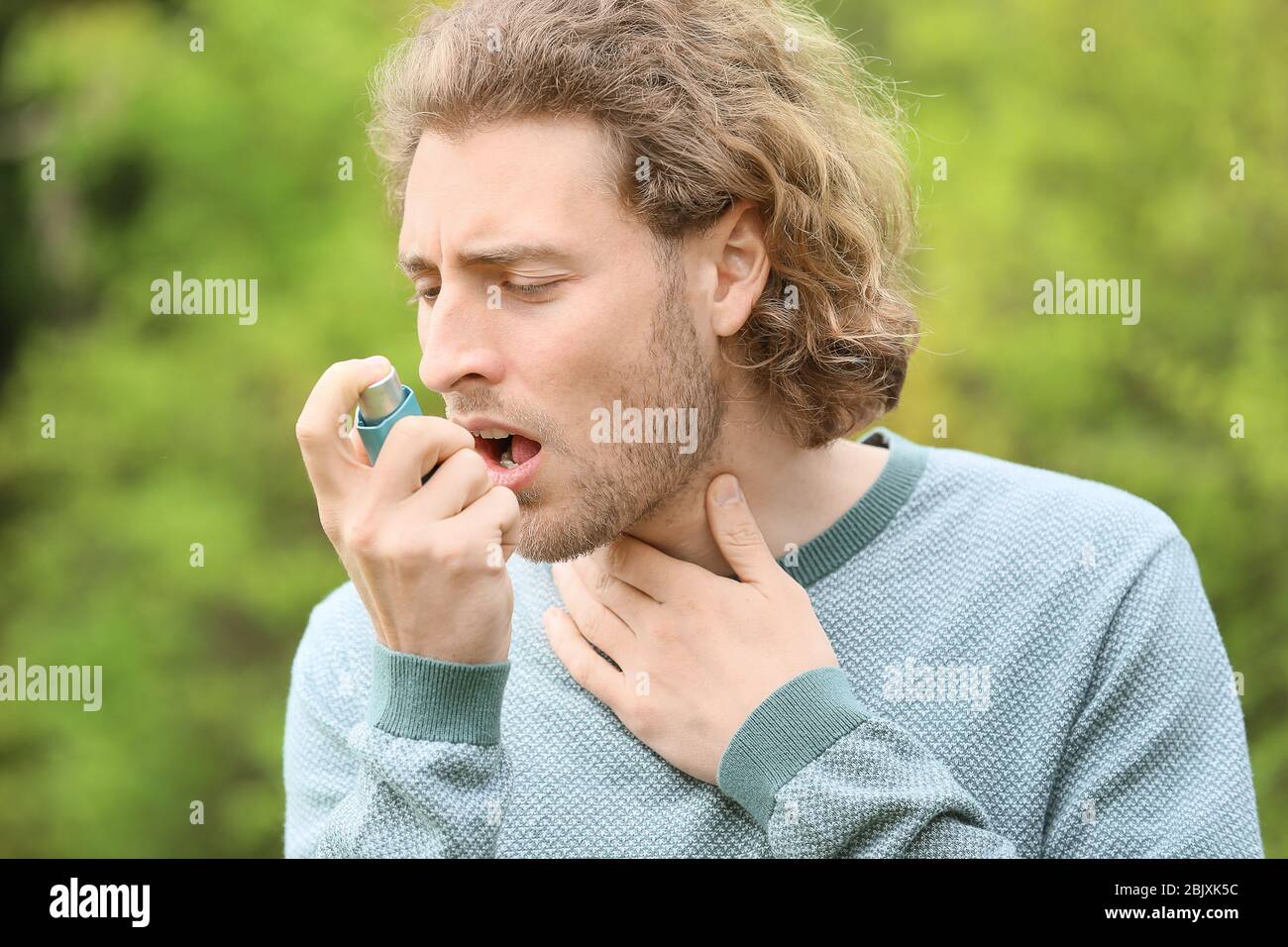 Man with inhaler having asthma attack on spring day Stock Photo - Alamy