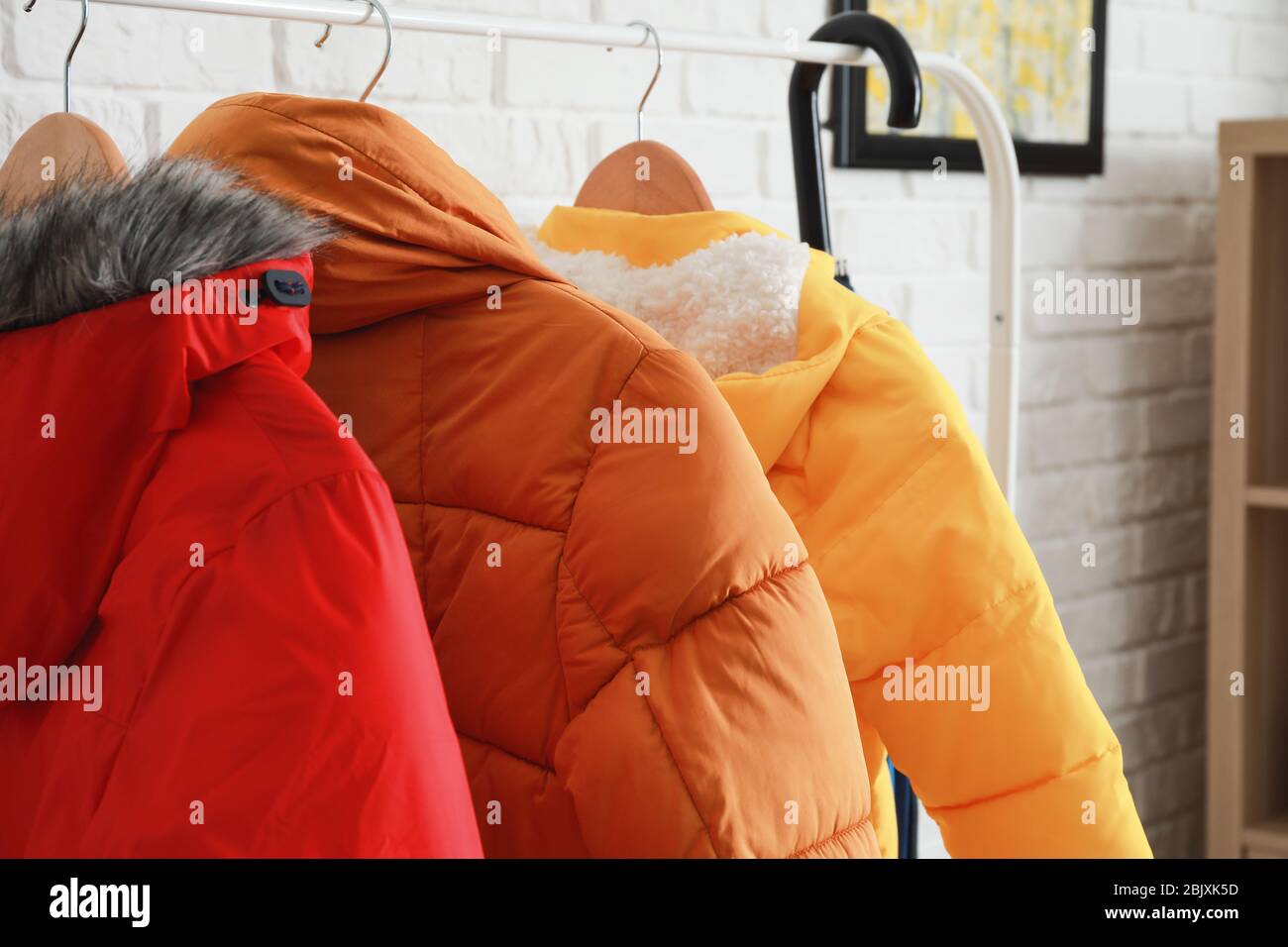 Rack with clothes in hall Stock Photo - Alamy