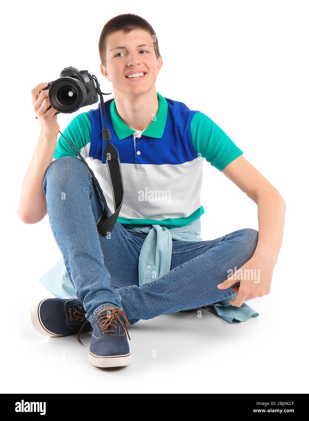 Teenage boy with photo camera on white background Stock Photo - Alamy