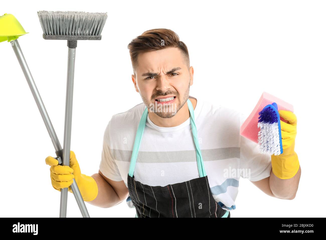 Angry young man with cleaning supplies on white background Stock Photo ...