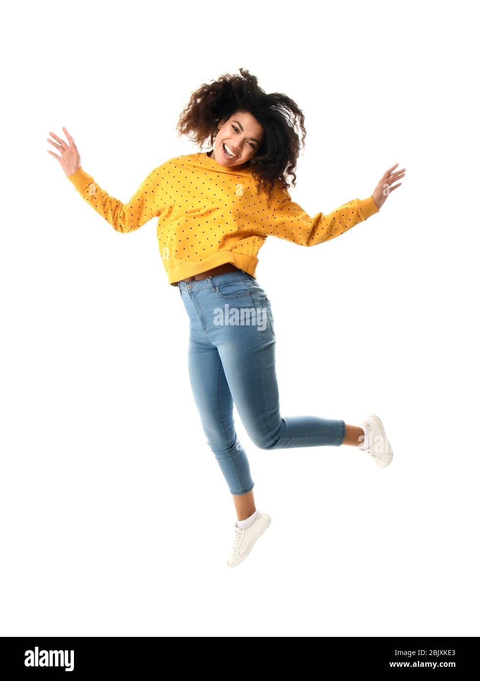 Jumping African-American woman on white background Stock Photo - Alamy