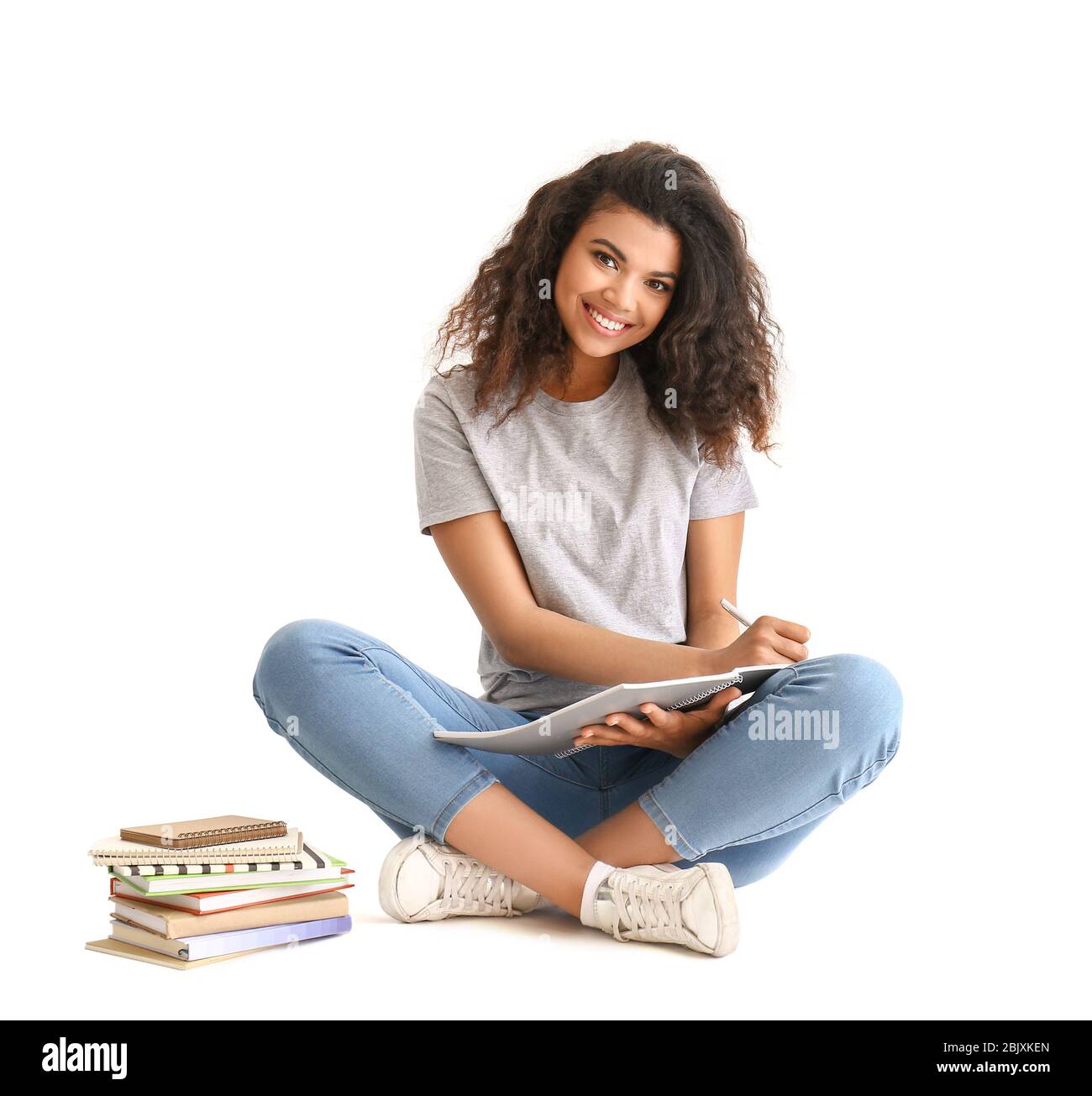 Portrait of cute African-American student on white background Stock ...