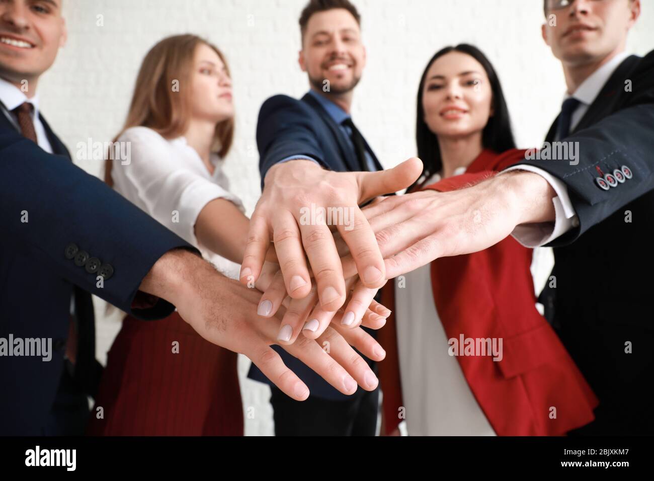 Business people putting hands hi-res stock photography and images - Alamy