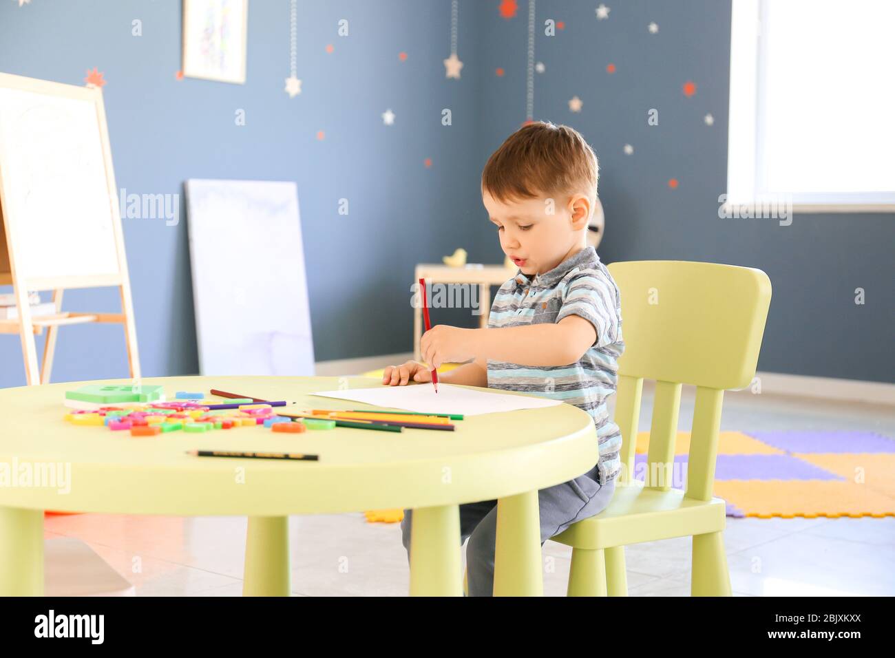 Little boy with autistic disorder in playroom Stock Photo - Alamy