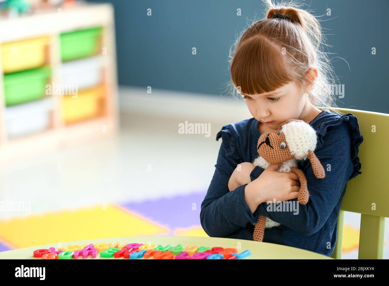 Little girl with autistic disorder in playroom Stock Photo - Alamy