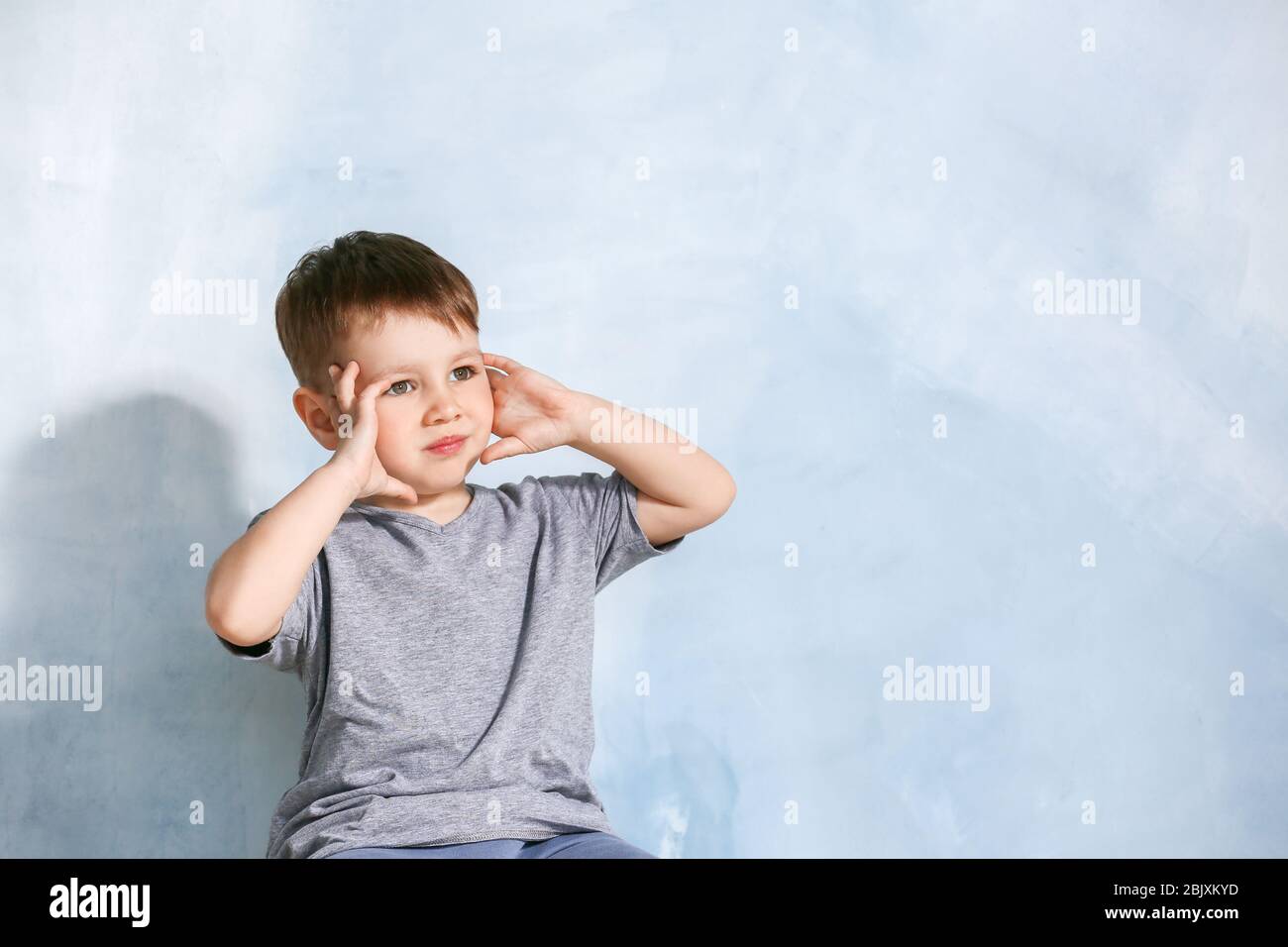 Little boy with autistic disorder on light background Stock Photo - Alamy