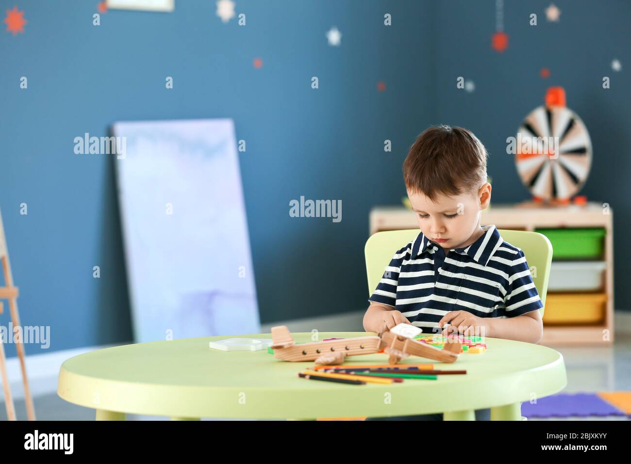 Little boy with autistic disorder in playroom Stock Photo - Alamy