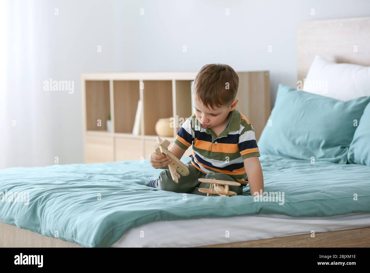 Little boy with autistic disorder playing on bed at home Stock Photo ...