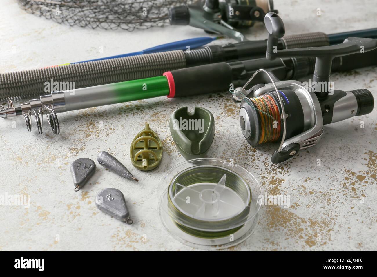 Different fishing equipment on light background Stock Photo - Alamy