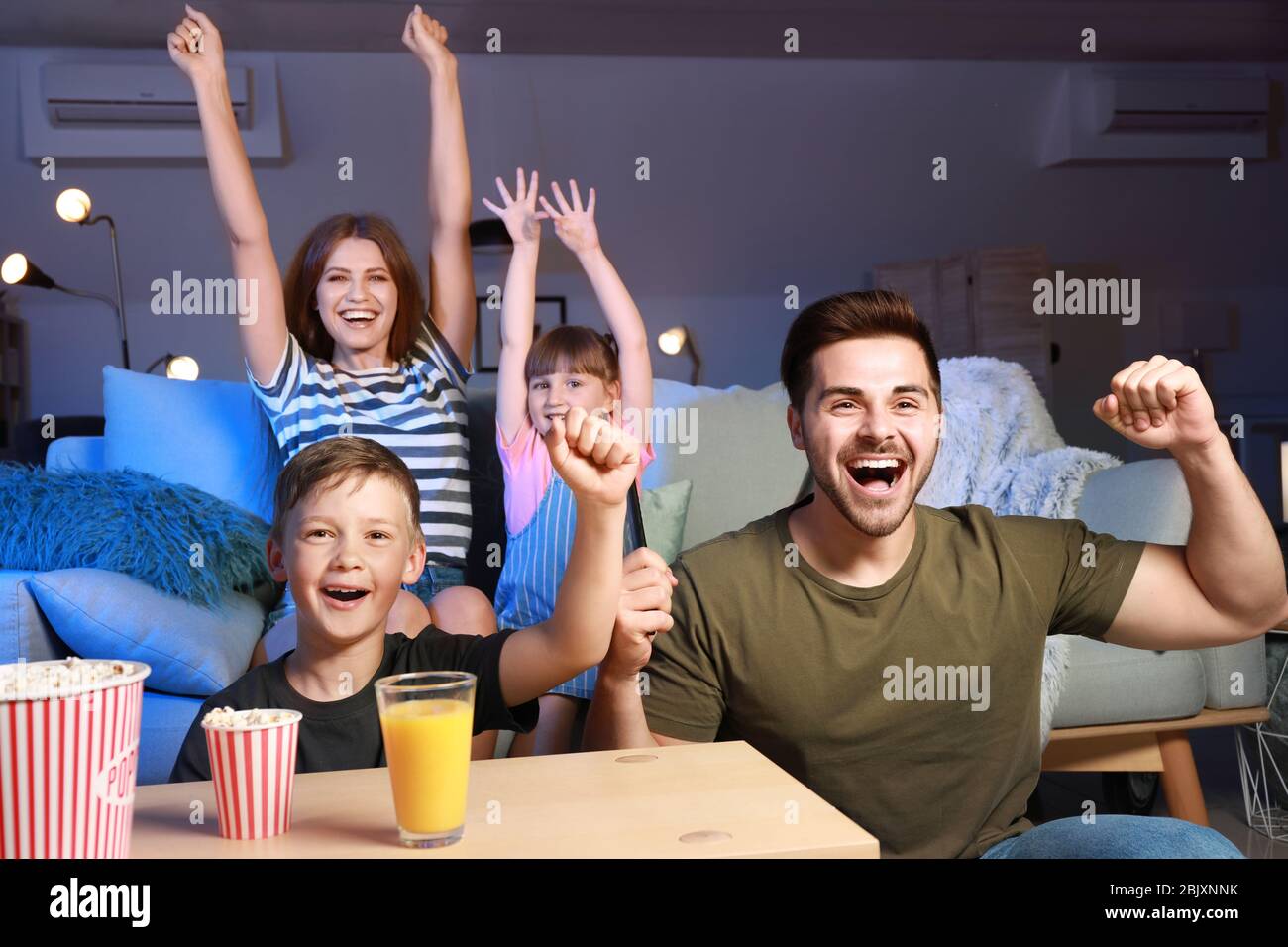 Happy family watching sports on TV at home Stock Photo - Alamy
