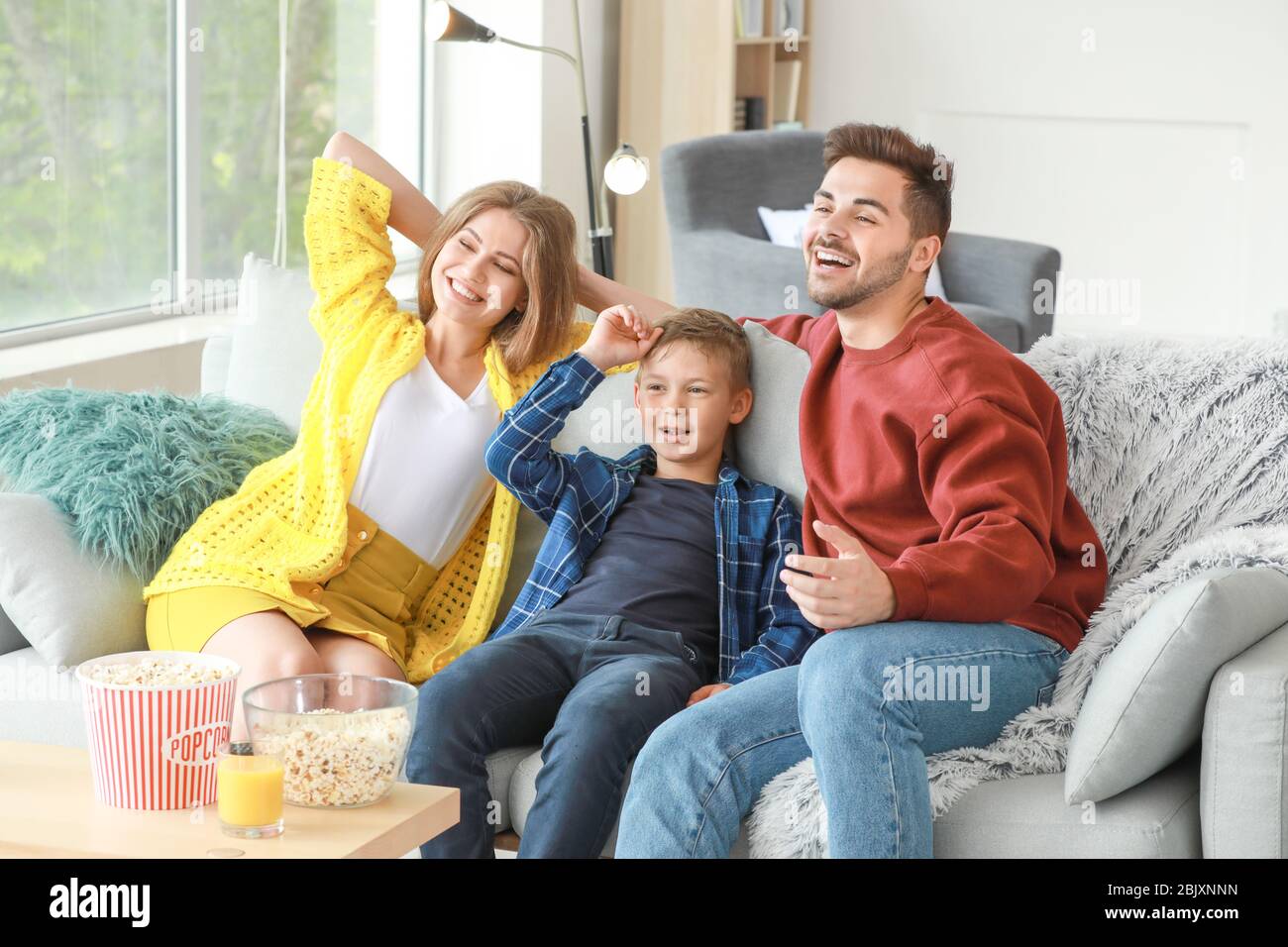 Happy family watching TV at home Stock Photo - Alamy