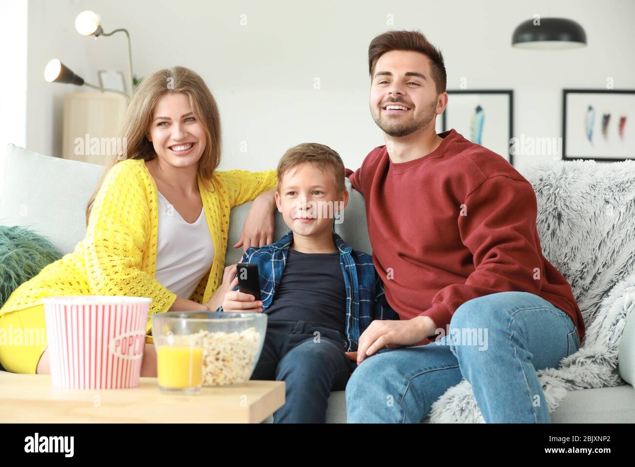 Happy family watching TV at home Stock Photo - Alamy