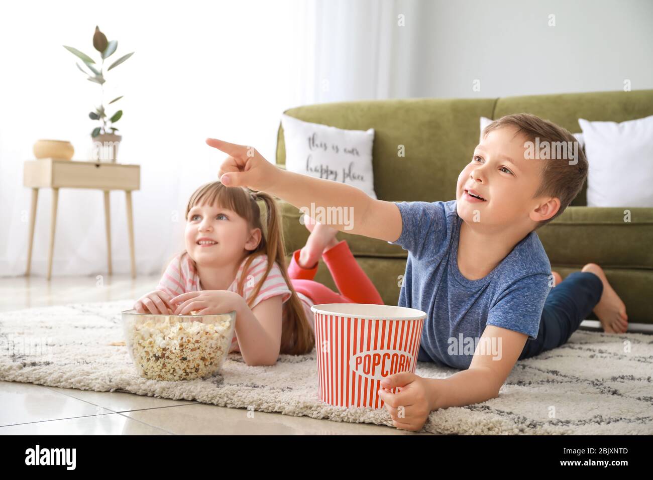 Little children watching TV at home Stock Photo - Alamy