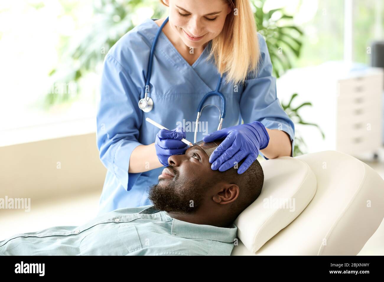 Doctor applying marking on hi-res stock photography and images - Alamy