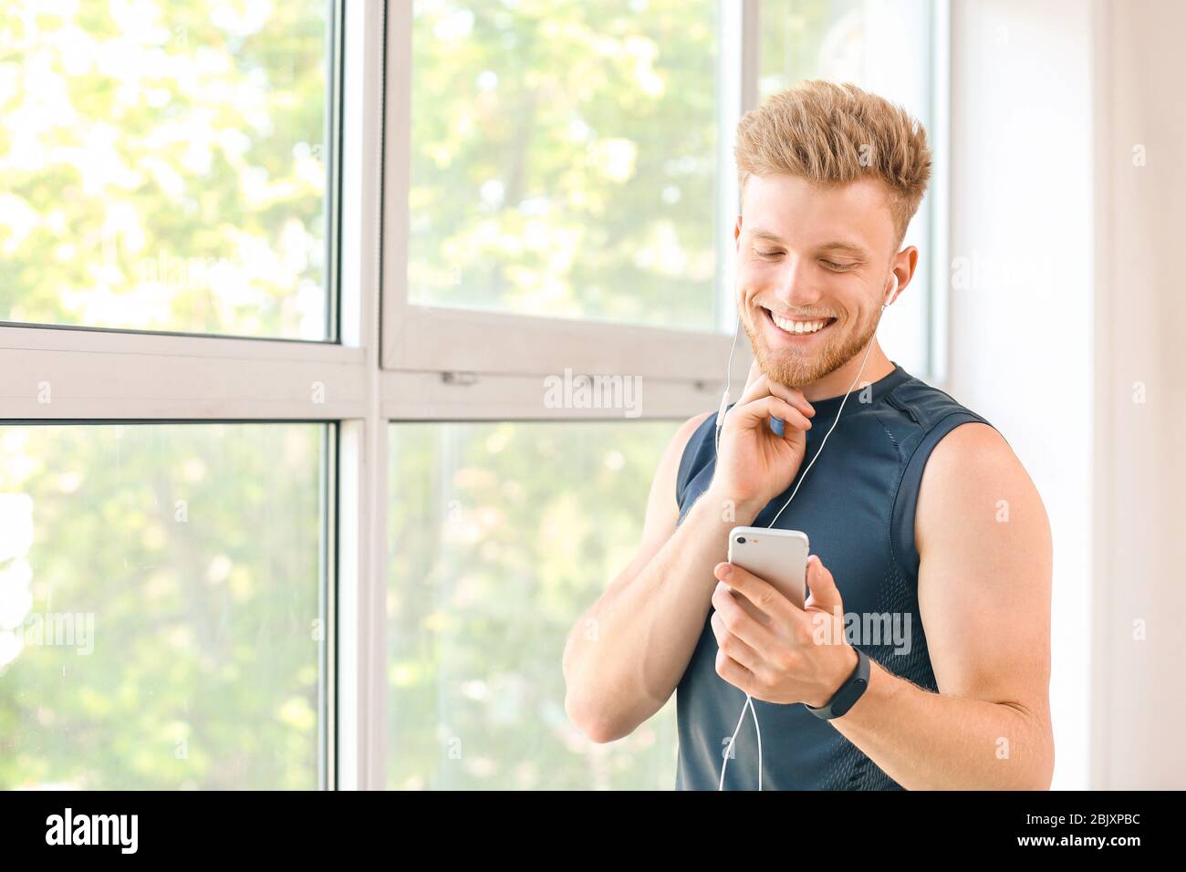 Sporty young man checking his pulse after training in gym Stock Photo ...
