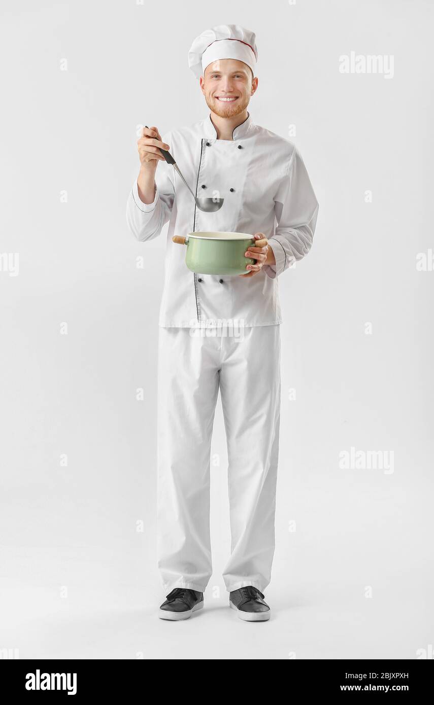 Handsome male chef with soup on white background Stock Photo - Alamy