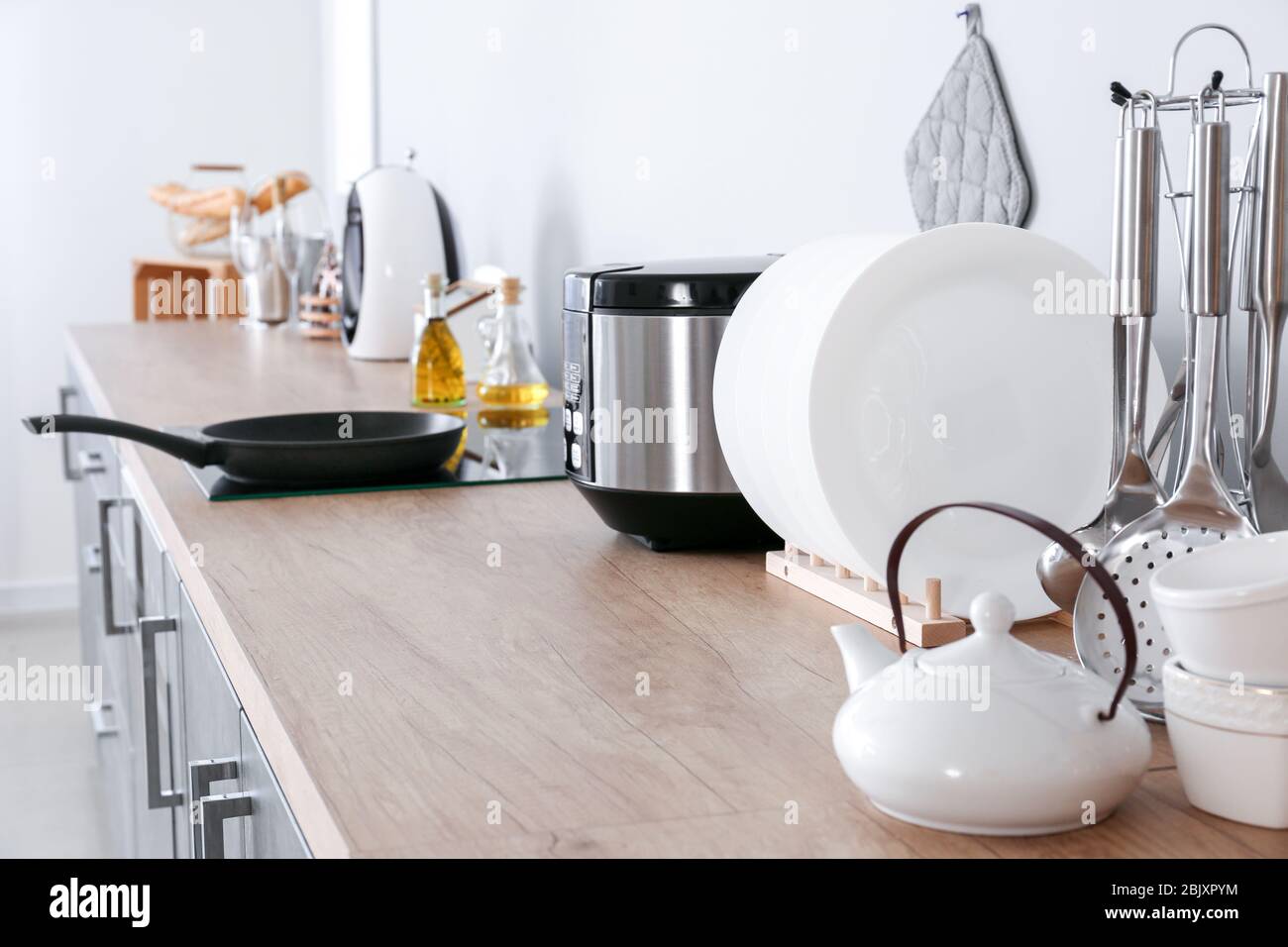 Different utensils and tableware in modern kitchen Stock Photo - Alamy