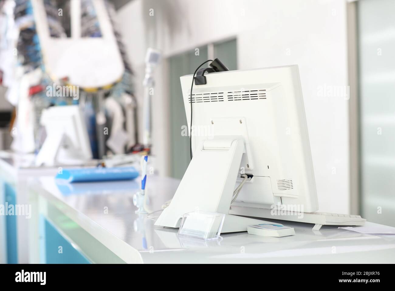 Computer at reception in modern dry-cleaner's Stock Photo - Alamy