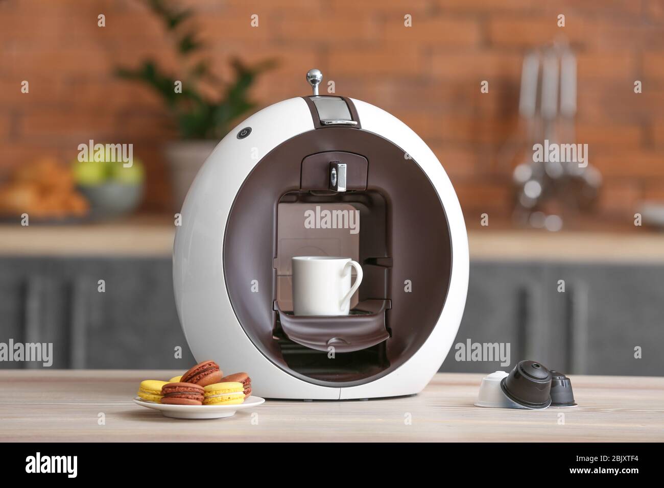 Modern coffee machine on table in kitchen Stock Photo - Alamy