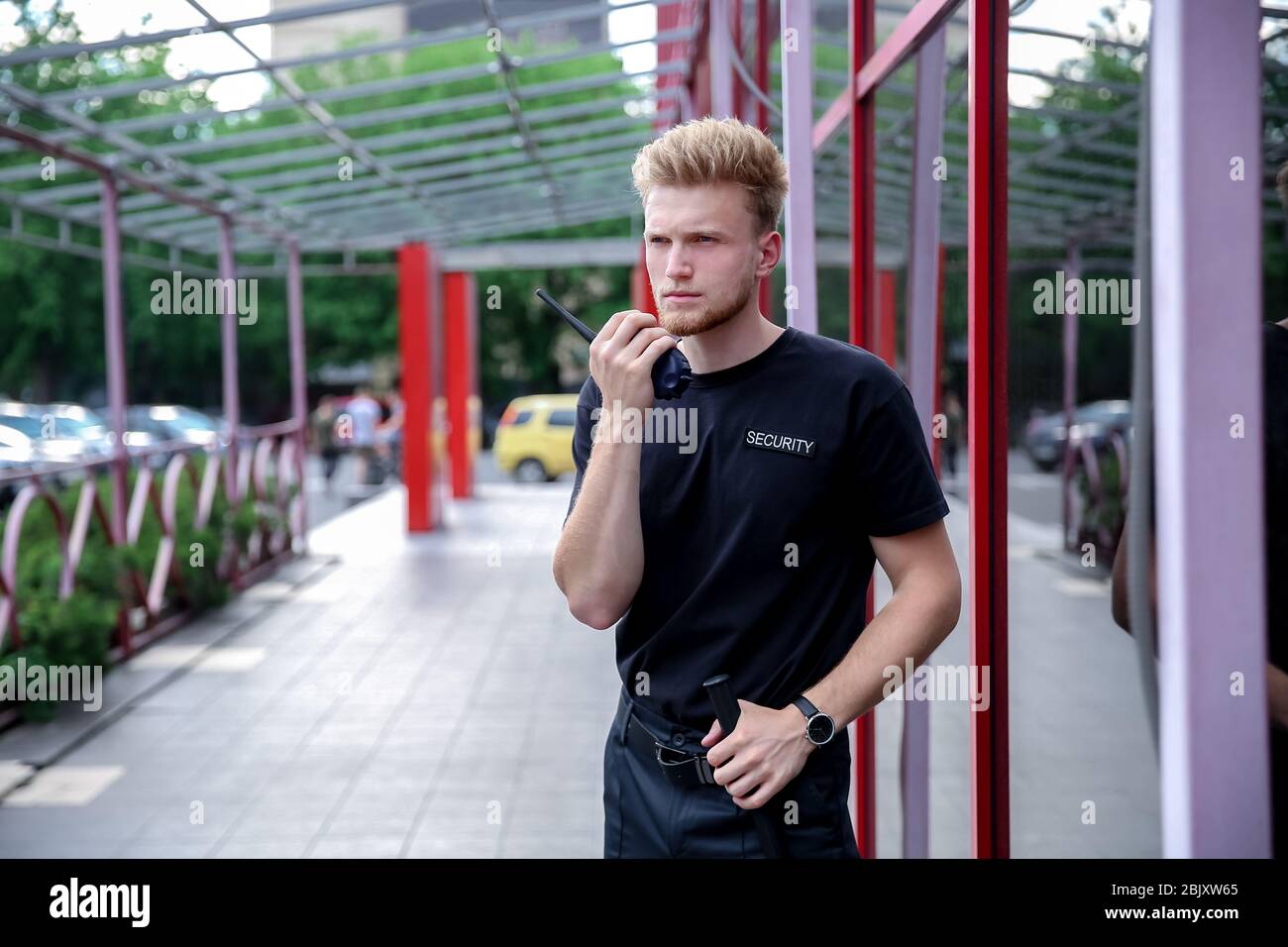 Handsome male security guard outdoors Stock Photo - Alamy