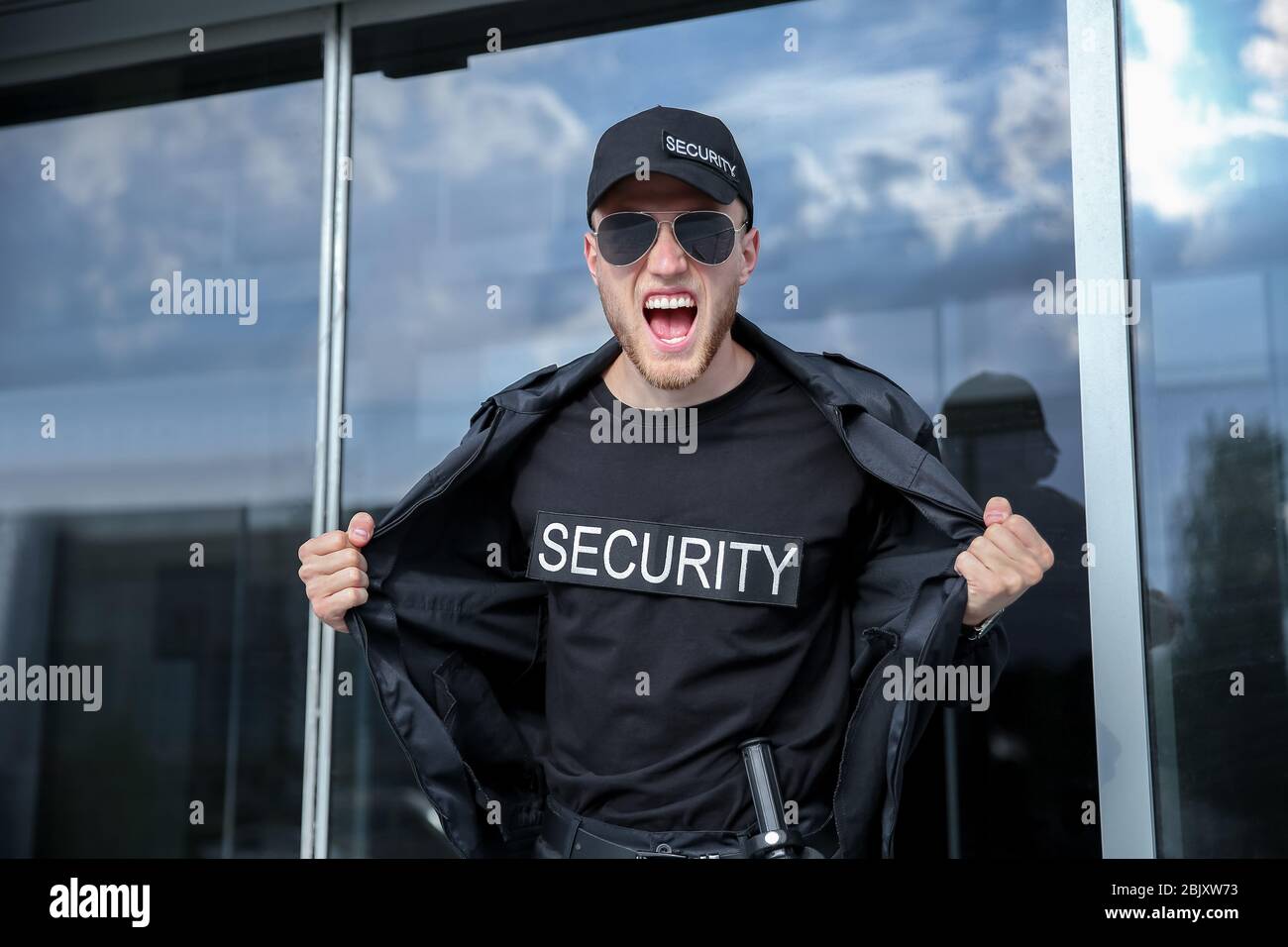 Aggressive male security guard outdoors Stock Photo - Alamy
