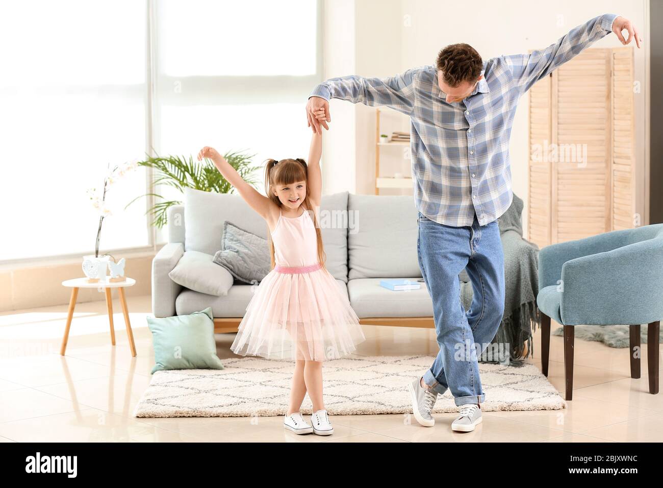 Happy father and his little daughter dancing at home Stock Photo - Alamy