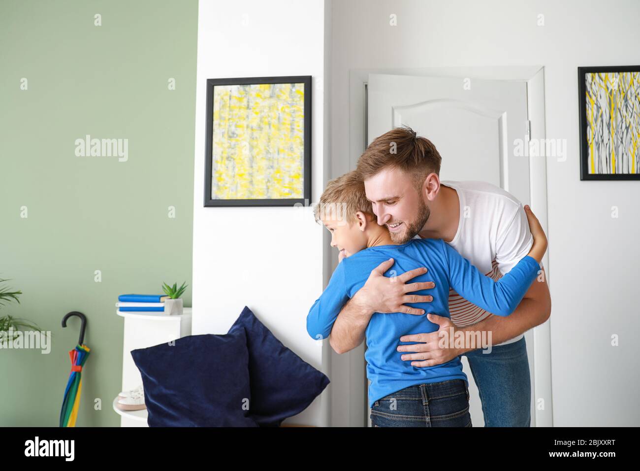 Happy little boy meeting his father at home Stock Photo - Alamy