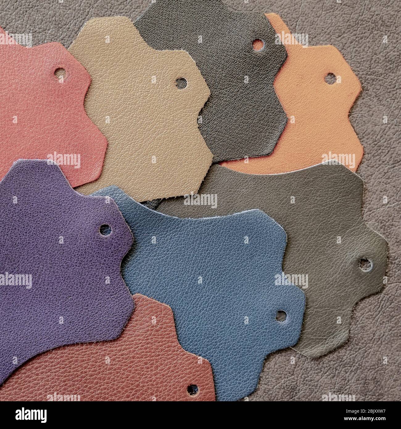 Set of colorful leather samples on dark leather, abstract square ...