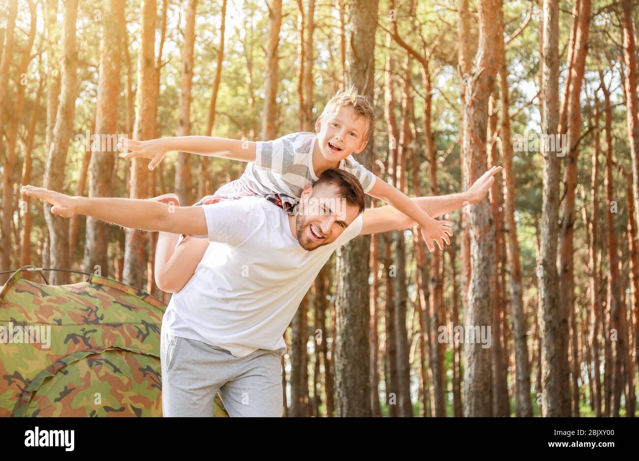 Portrait of happy father and son in forest Stock Photo - Alamy