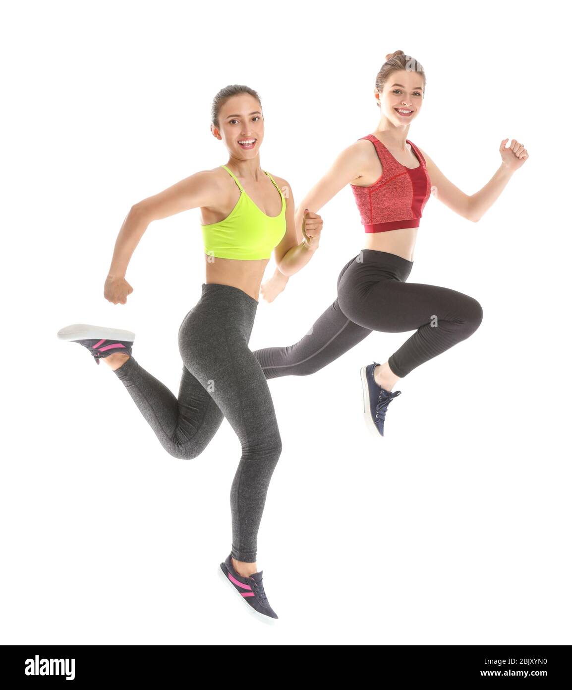 Running sporty women on white background Stock Photo - Alamy