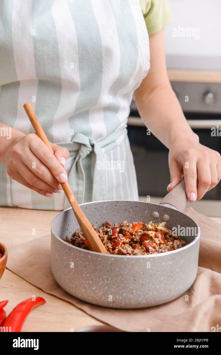 Woman cooking chili con carne hi-res stock photography and images - Alamy