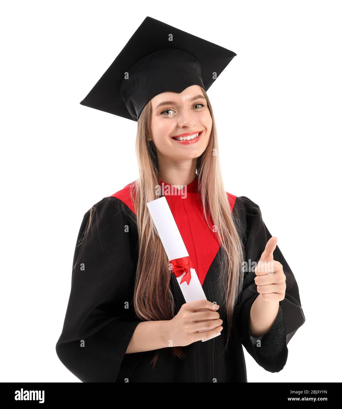 Young female student in bachelor robe showing thumb-up on white ...
