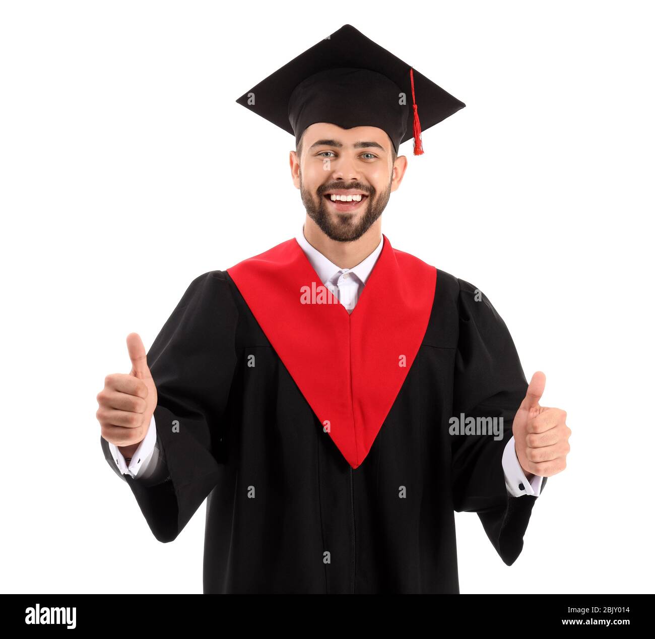 Young male student in bachelor robe showing thumb-up on white ...
