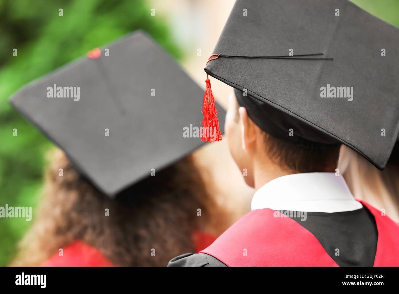 Young students in bachelor robes outdoors Stock Photo - Alamy