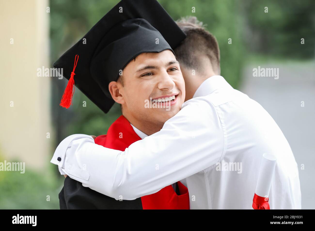 Professor greeting young student on his graduation day Stock Photo - Alamy