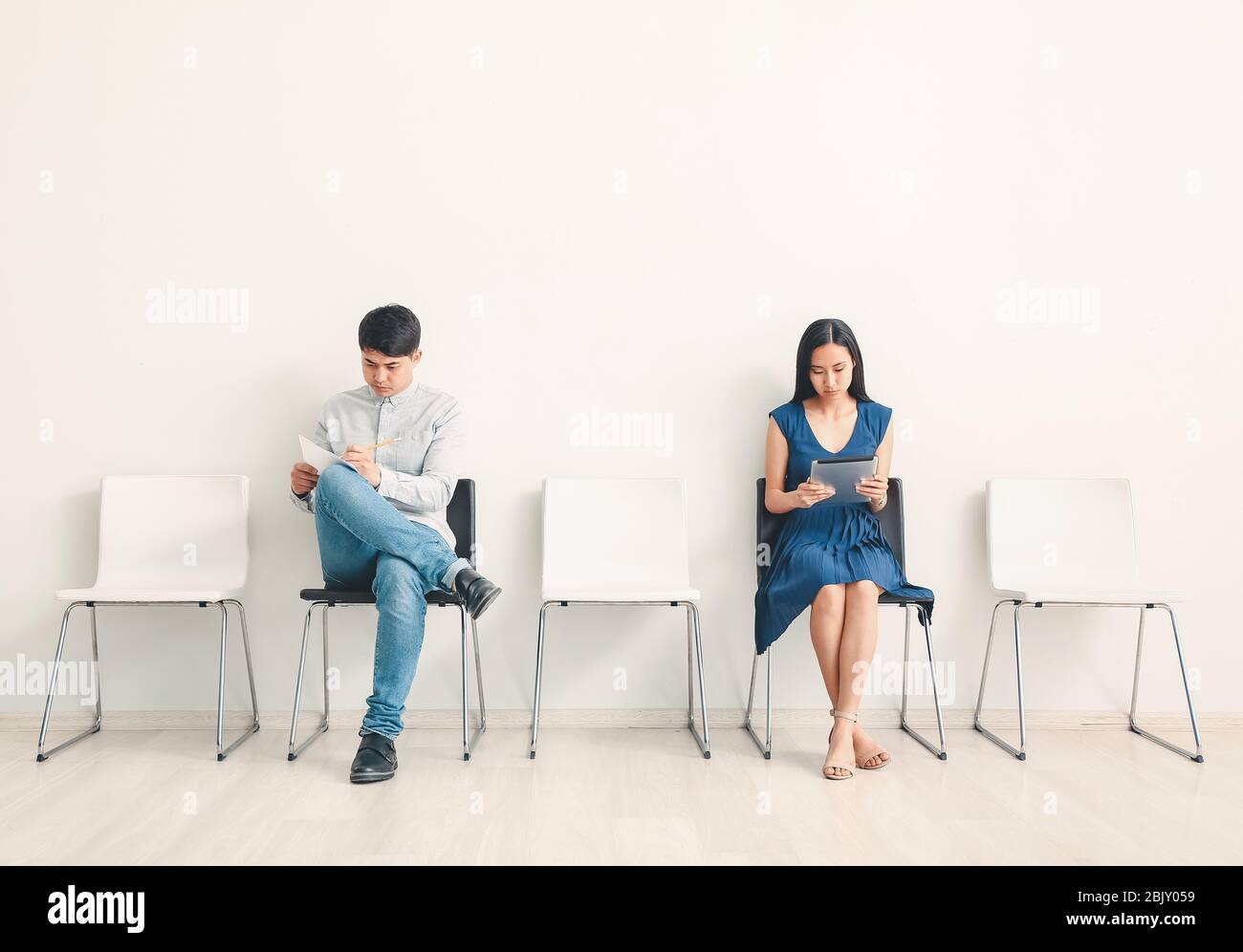 Young people waiting for job interview indoors Stock Photo - Alamy